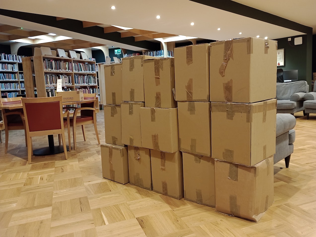 Cardboard boxes in the Heythrop Library’s reading room. – Heythrop Library